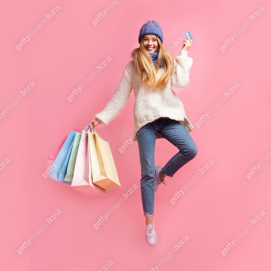 Smiling winter girl holding credit card, jumping with shopping bags 이미지 ... Smiling winter girl holding credit card, jumping with shopping bags 이미지 ...